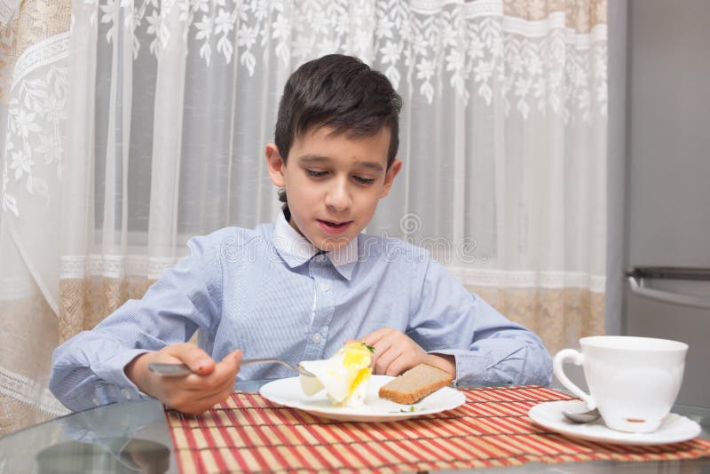 Boy Eating Soup at the Kitchen Table Stock Photo - Image of kitchen ...