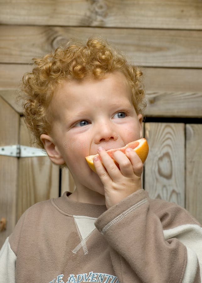 Boy eating Sour Fruit stock photo. Image of child, tasting - 6540996