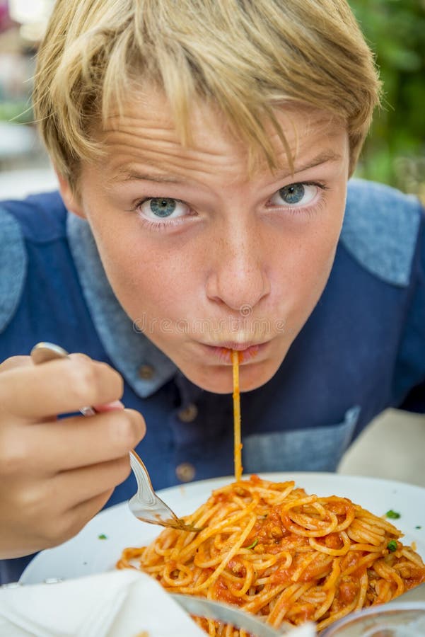 Boy eating spaghetti stock photo. Image of eyes, bolognese - 91352668