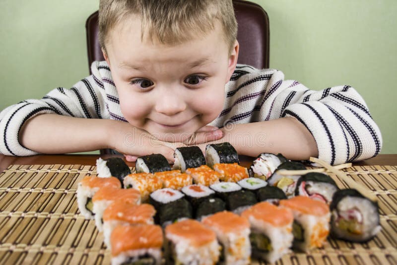 Boy eating sushi stock photo. Image of food, surprise - 67643398