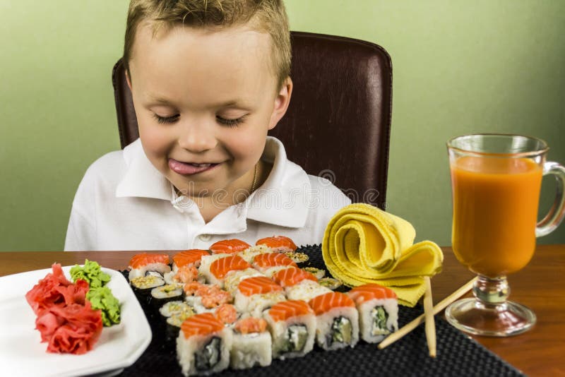 Boy eating sushi stock photo. Image of food, surprise - 67643398