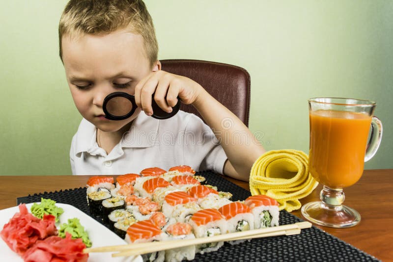 Boy eating sushi stock photo. Image of food, surprise - 67643398