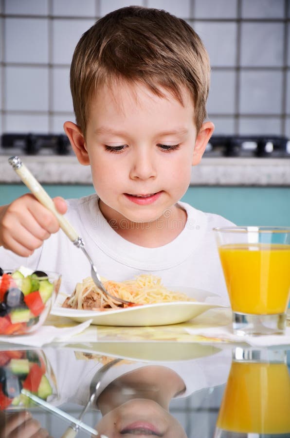 Boy Eating at the Table, Looking at the Plate Horizontal Stock Photo ...