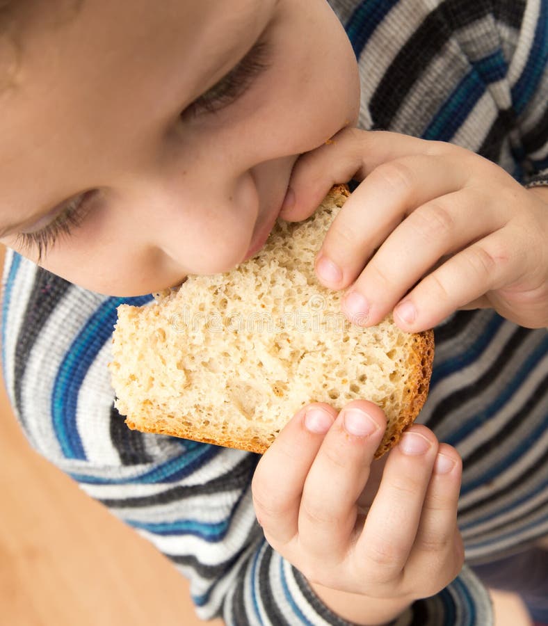 Boy eats bread stock photo. Image of face, white, smiling - 110538954