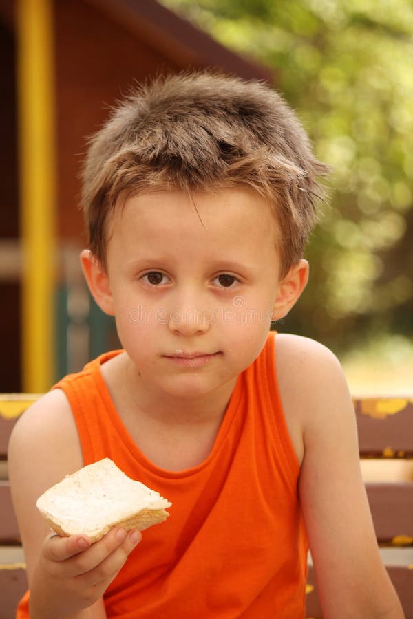 Boy eats buttery bread stock photo. Image of affection - 46609338