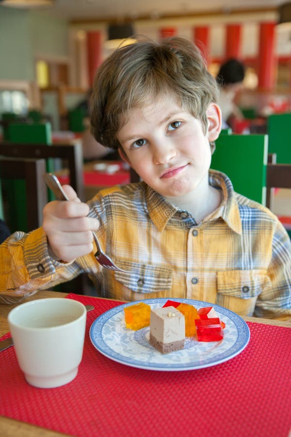 The boy eats dessert stock photo. Image of dislike, hand - 38923234