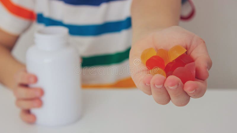 The Boy Eats Jelly Beans or Takes Vitamins Stock Photo - Image of child ...