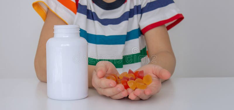 The Boy Eats Jelly Beans or Takes Vitamins Stock Photo - Image of cute ...