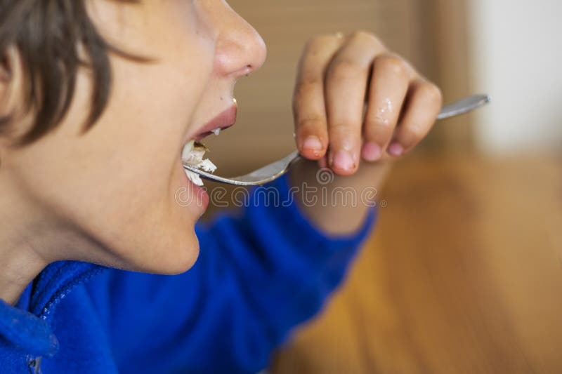 Boy Eats Pieces of Stew from a Fork with His Mouth Stock Photo - Image ...