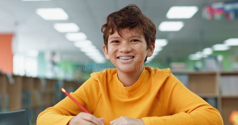 Boy, Education and Happy at Library in School with Notebook for ...