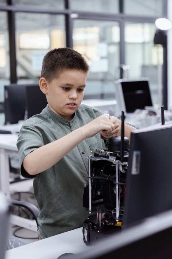 Boy Learning To Repair Electrical Appliances. Education on Table at ...