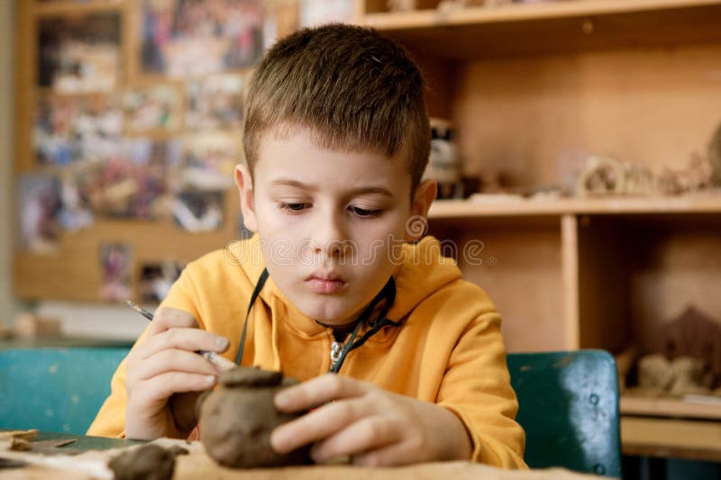 The Boy is Engaged in Clay Modeling in a Ceramics Class Stock Image ...
