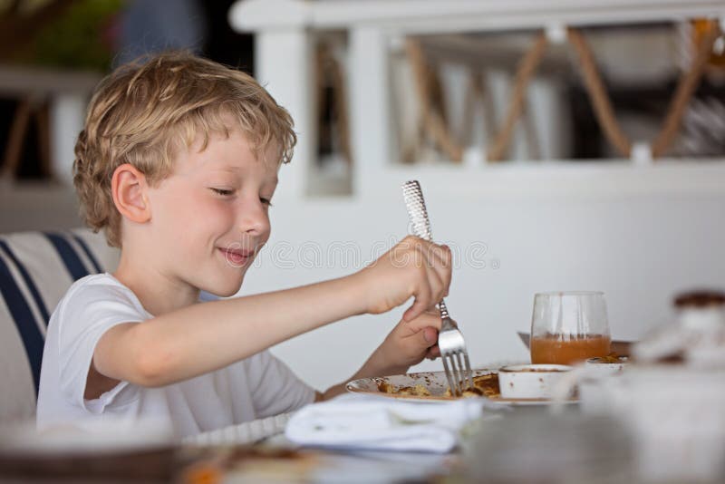 Boy enjoying breakfast stock image. Image of eating - 115770957