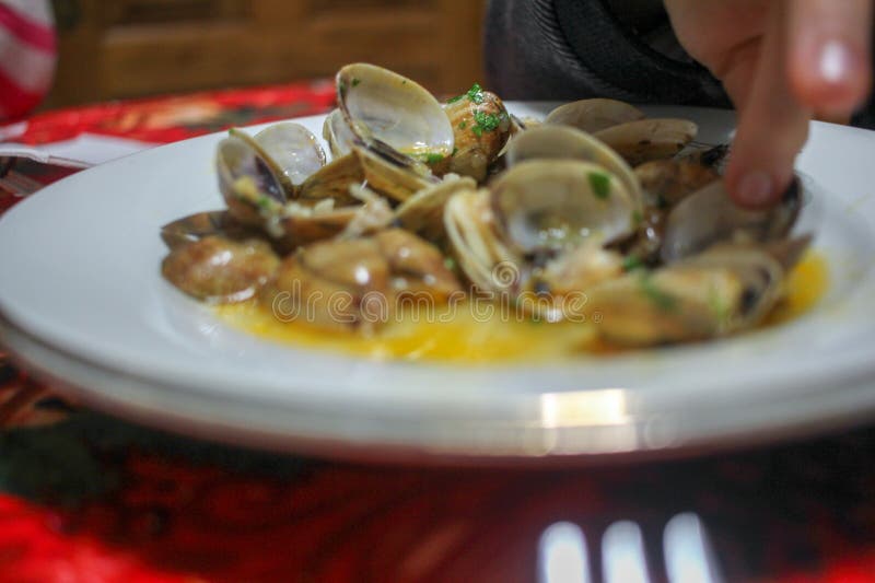 A Boy Enjoying Clams at Home Stock Photo - Image of hand, shell: 380774912