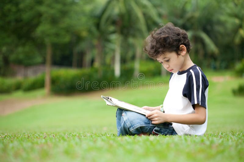 Boy Enjoying His Reading Book in Outdoor Park Stock Image - Image of ...