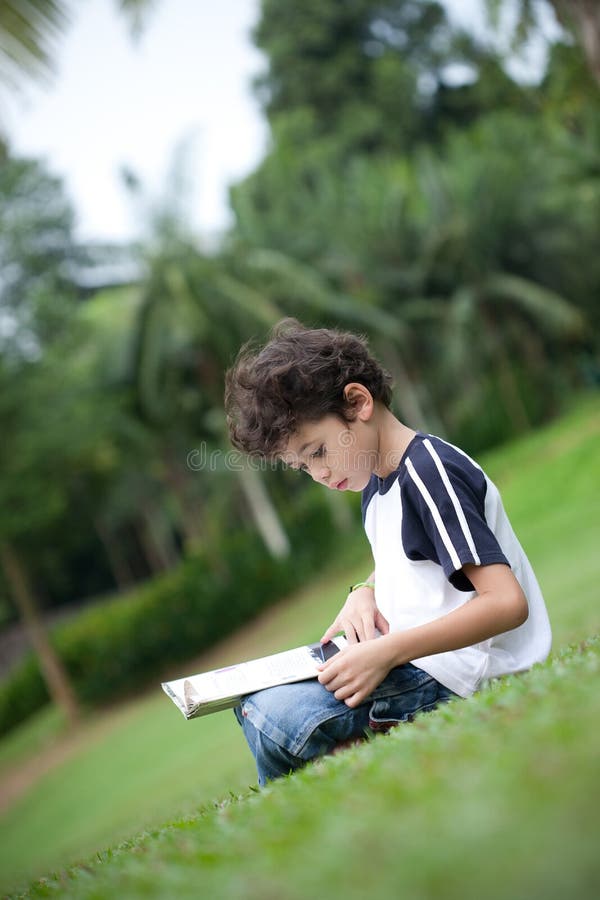 Boy Enjoying His Reading Book in Outdoor Park Stock Photo - Image of ...