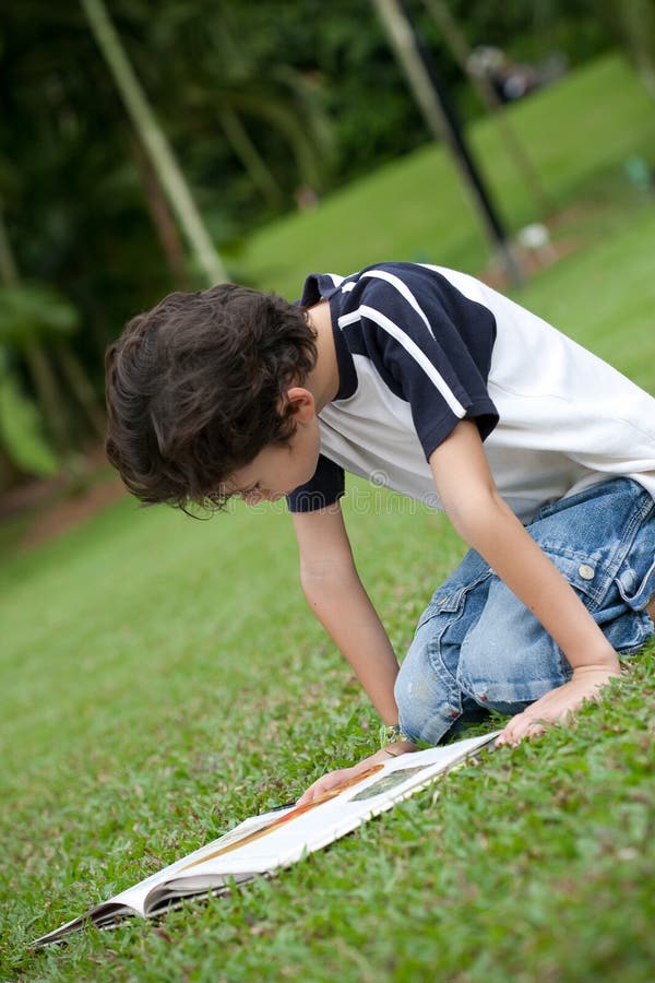 Boy Enjoying His Reading Book in Outdoor Park Stock Image - Image of ...