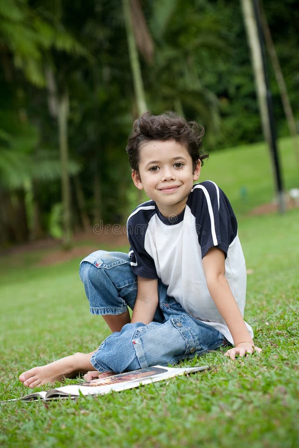 Boy Enjoying His Reading Book in Outdoor Park Stock Photo - Image of ...
