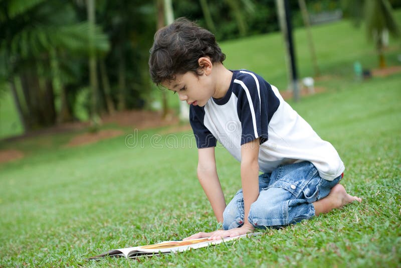 Boy Enjoying His Reading Book in Outdoor Park Stock Image - Image of ...