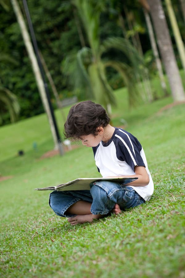 Boy Enjoying His Reading Book in Outdoor Park Stock Photo - Image of ...