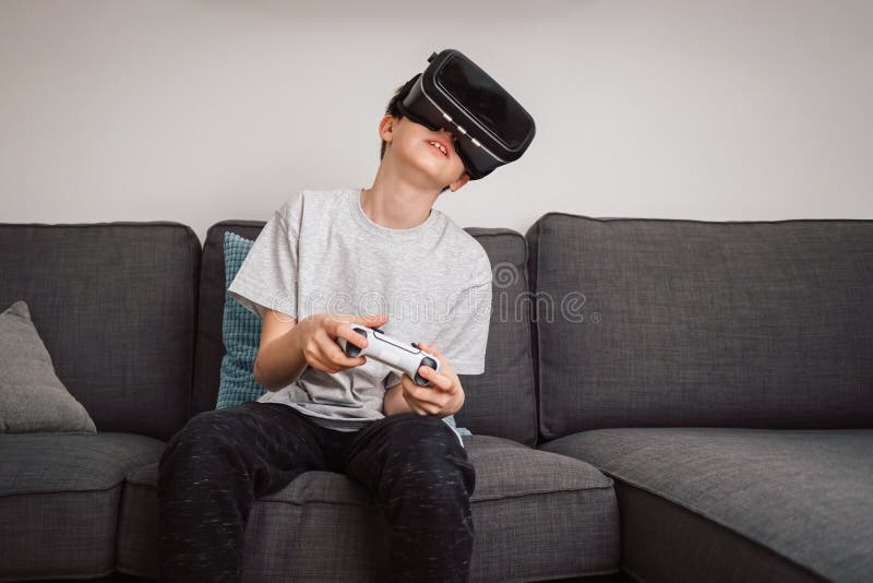 Boy Enjoying at Home, Gaming Using VR Goggles and a Simulator Stock ...