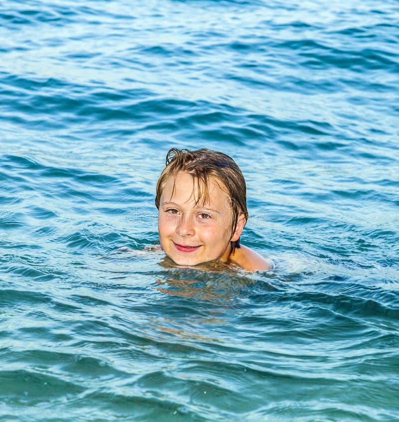 Boy Enjoys the Beautiful Water of the Ocean Stock Photo - Image of ...