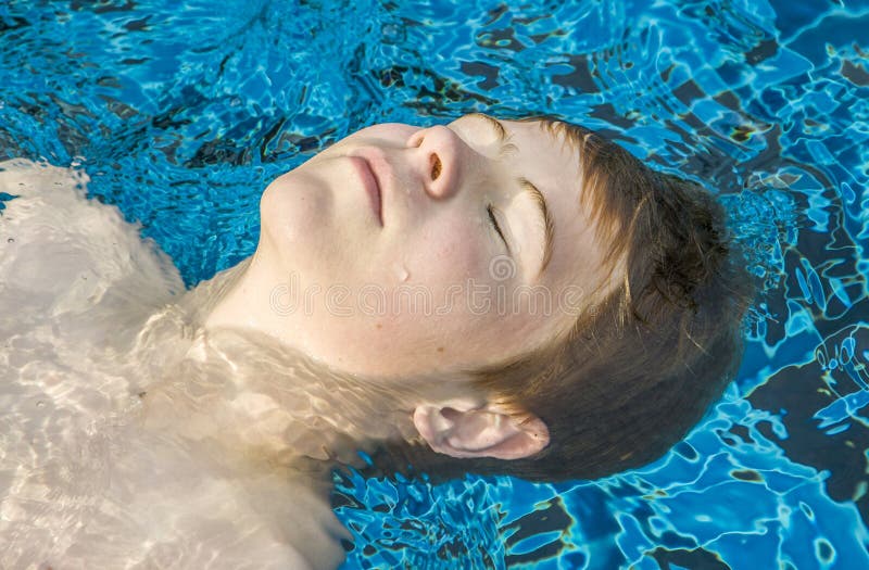 Boy Enjoys Floating on His Back Stock Photo - Image of concentration ...