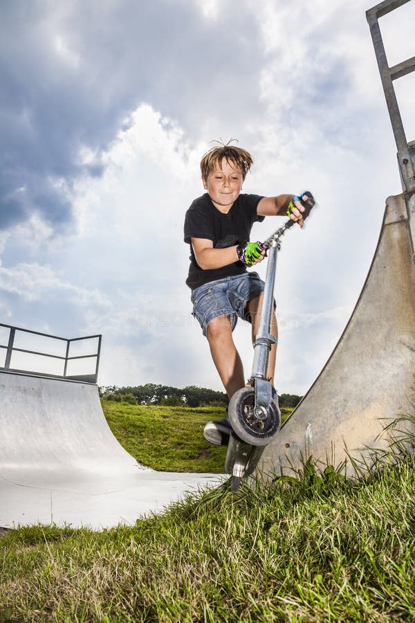 Young Boy Enjoys Riding Scooter Stock Photos - Free & Royalty-Free ...