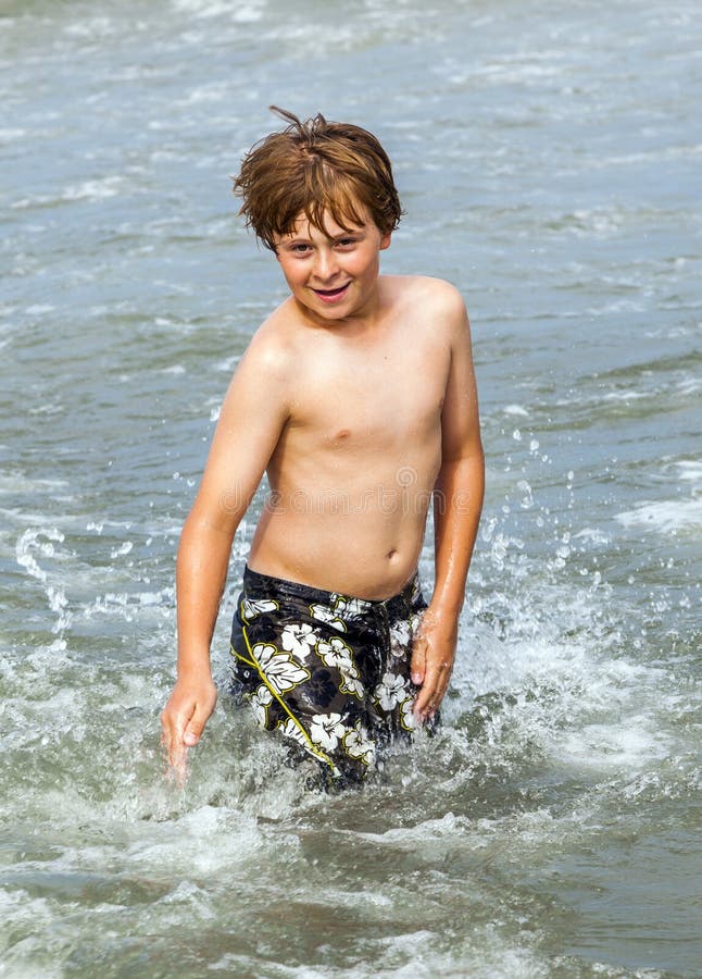 Boy Enjoys the Waves in the Ocean Stock Image - Image of boys, beach ...