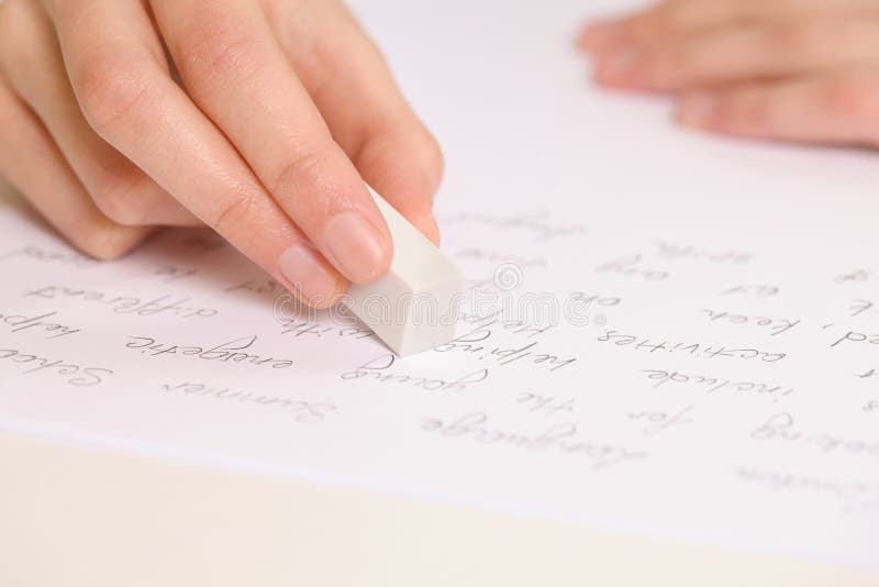 Boy Erasing Mistake in His Notebook at White Desk, Closeup Stock Photo ...