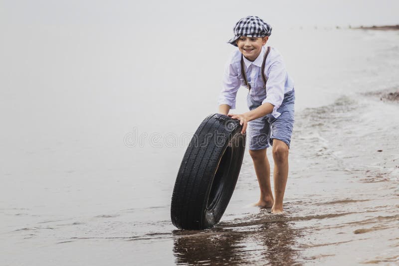A Boy in the Evening at the Tyre Rolling Stock Photo - Image of male ...