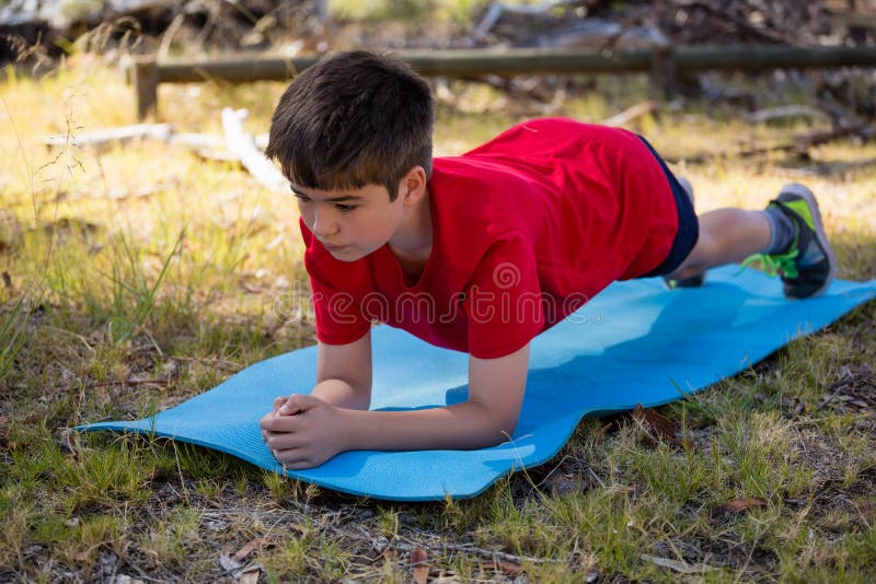 Boy Exercising on Exercise Mat during Obstacle Course Training Stock ...