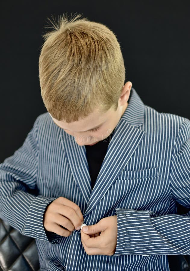 Boy Fastening a Button on His Jacket Stock Image - Image of child, male ...