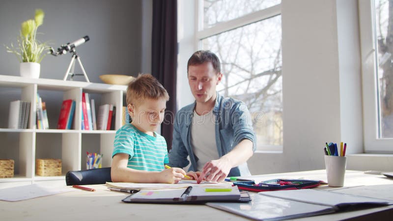 Boy and Father are Doing Homework at the Table. Cute Child is Learning ...