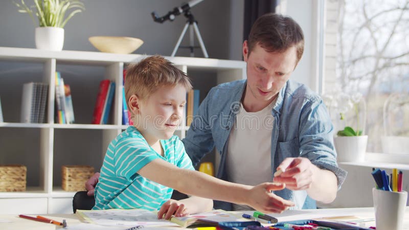 Boy and Father are Doing Homework at the Table. Cute Child is Learning ...