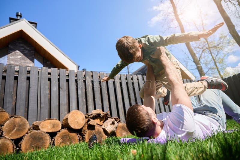 Boy and Father Play in the Yard of Their House Stock Photo - Image of ...