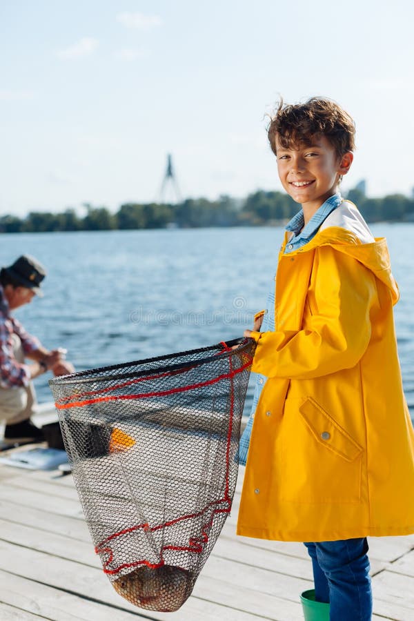 Boy Feeling Satisfied while Having Fish in the Fishing Net Stock Photo ...
