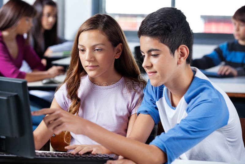 Boy with Female Friend Pointing at Computer Screen Stock Image - Image ...