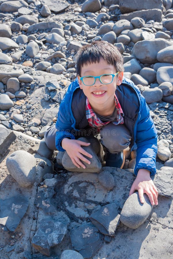 Boy Finding Fossil on the Beach Stock Image - Image of beach, finding ...