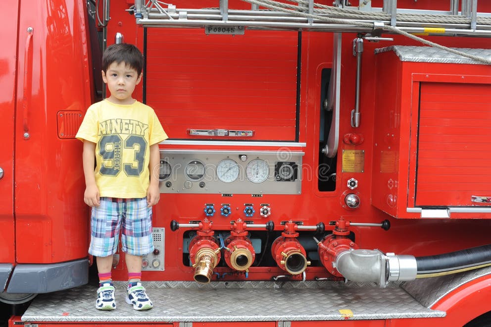 Boy on a fire engine stock photo. Image of curious, face - 21426618