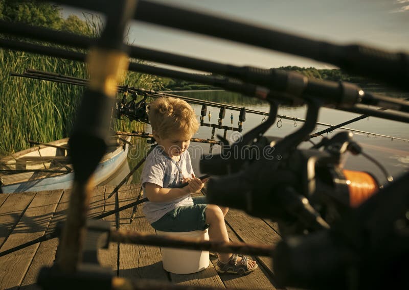 Boy Fishing from Dock on Lake Stock Photo - Image of scenic, young ...