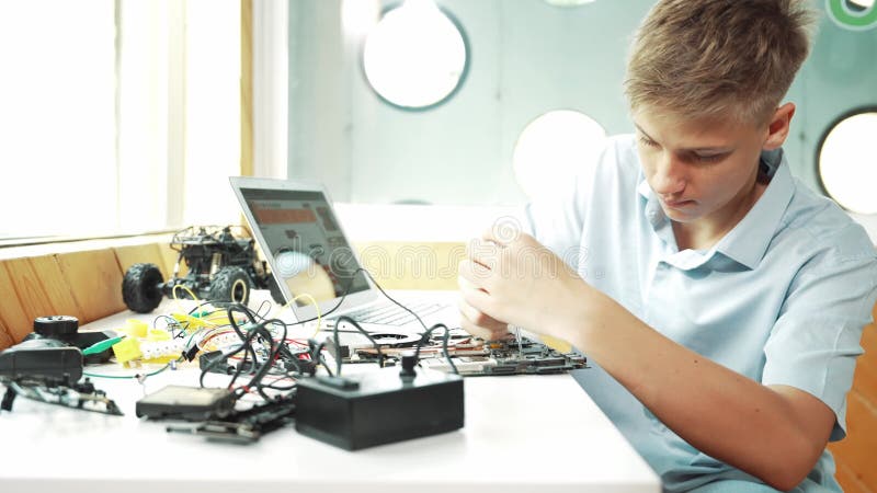 Boy Fixing Main Board while Study Construction by Using Laptop ...