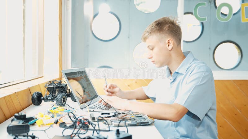 Boy Fixing Main Board while Study Construction by Using Laptop ...