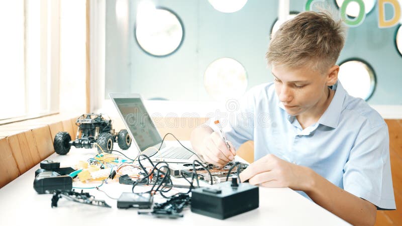 Boy Fixing Main Board while Study Construction by Using Laptop ...