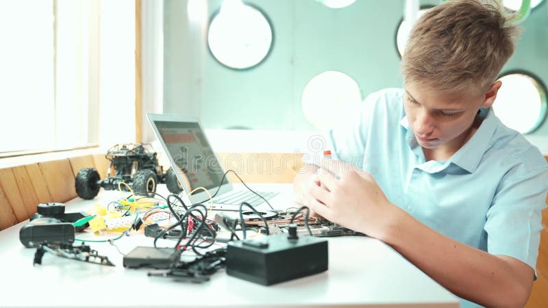 Boy Fixing Main Board while Study Construction by Using Laptop ...
