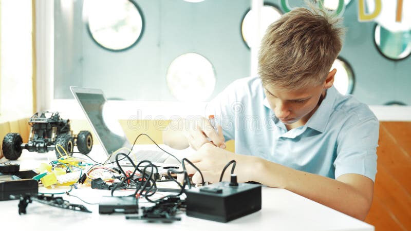 Boy Fixing Main Board while Study Construction by Using Laptop ...