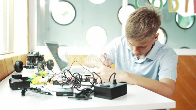 Boy Fixing Main Board while Study Construction by Using Laptop ...