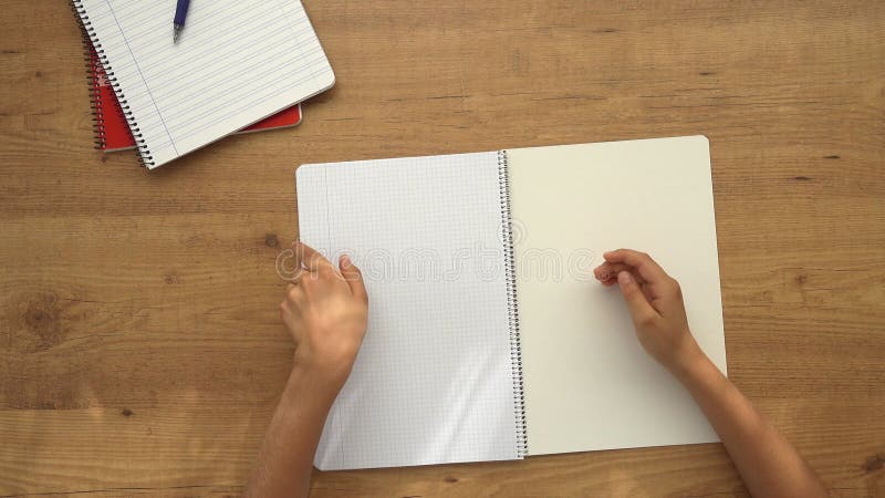 Boy Flipping Pages in Notebook . Child Doing Homework, he Browsing ...