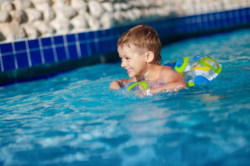 Boy Floating on an Inflatable Circle in the Pool. Swimming into Resort ...