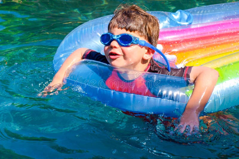 Boy Floating on a Lilo Inflatable in a Swimming Pool Stock Photo ...